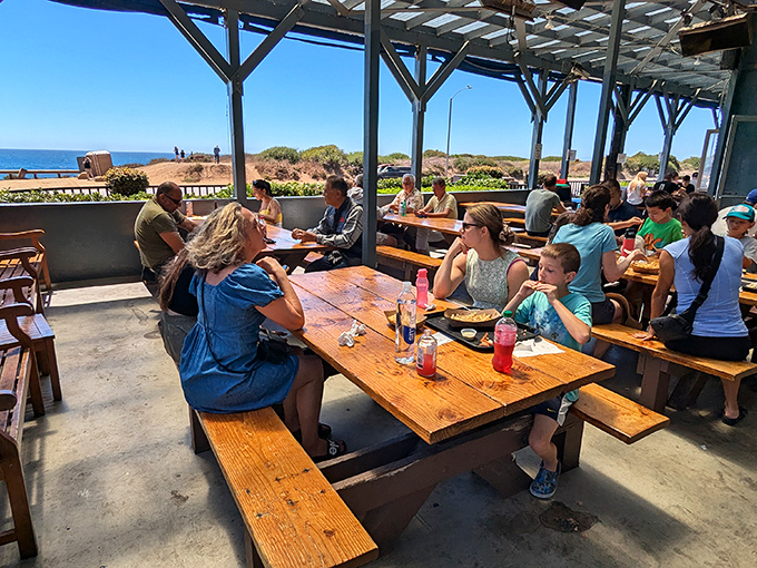 The outdoor dining area – where strangers become temporary friends, united by ocean views and the universal language of "pass the tartar sauce."