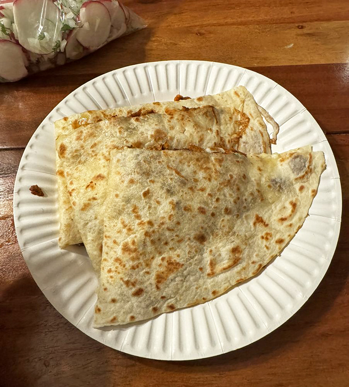 This quesadilla isn't just food—it's therapy in a tortilla, with cheese pulling double duty as both ingredient and emotional support.