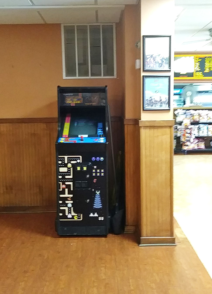Even the vintage arcade game knows it's playing second fiddle to the real entertainment—those magnificent cheesesteaks just feet away.