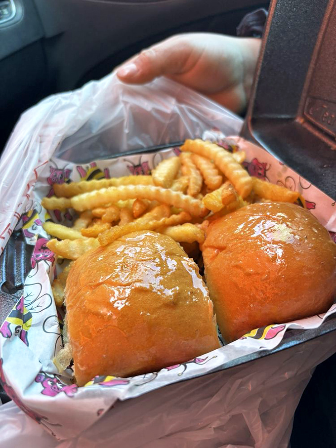 The perfect to-go order – crispy fries and golden rolls nestled in flying pig paper, ready to make your car smell like heaven all the way home.