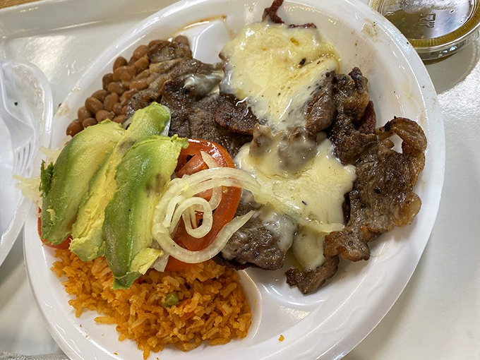The Bistec Con Queso plate proves that melted cheese improves everything it touches, especially when paired with perfectly grilled steak and avocado.