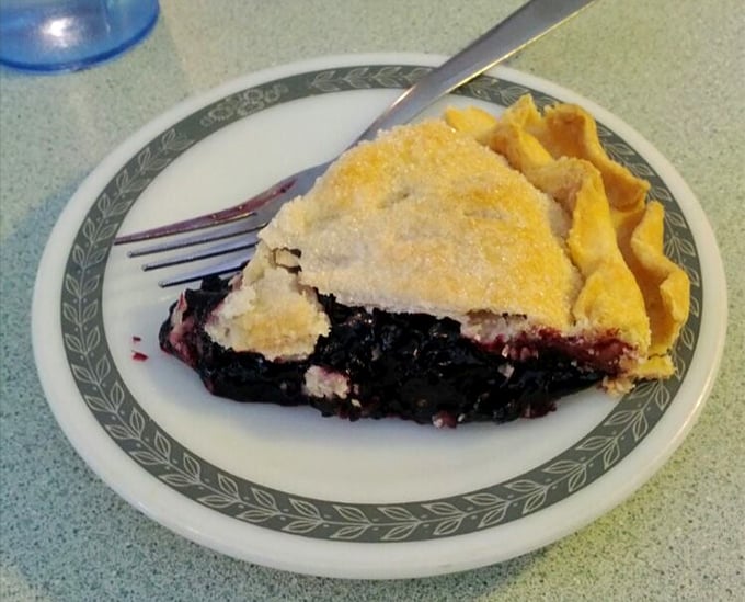A slice of black raspberry pie that makes you understand why people used to cool pies on windowsills—and why neighbors would be tempted to steal them.