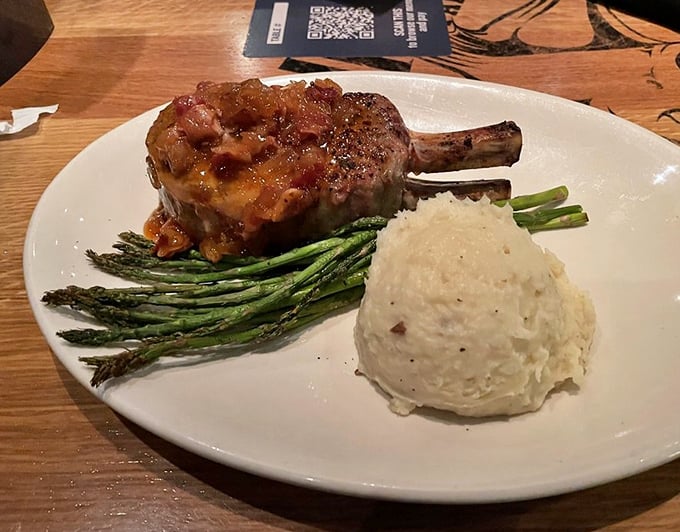 This pork chop isn't just dinner—it's a statement piece, a culinary sculpture that happens to taste even better than it looks.