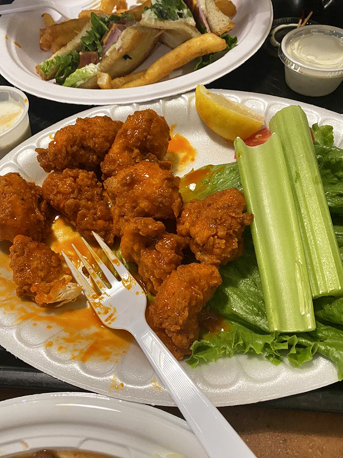 Buffalo wings with the perfect sauce-to-crisp ratio, accompanied by celery sticks that nobody will eat but everyone appreciates for the gesture.