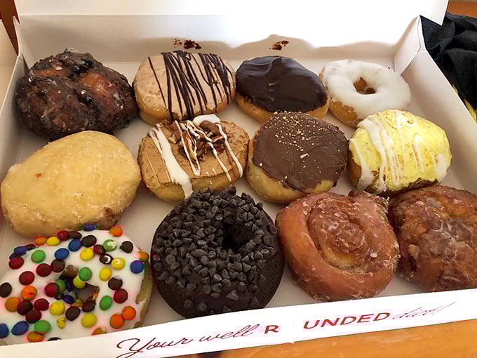 A box of assorted joy. Like a family reunion where everyone actually gets along, these diverse donuts create harmony in variety.