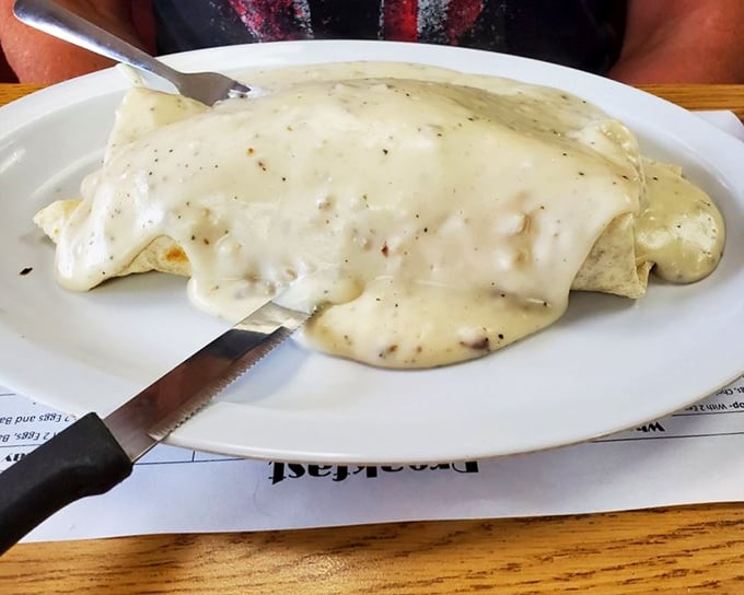 This isn't just a breakfast burrito smothered in country gravy—it's what happiness looks like before noon in the Midwest.