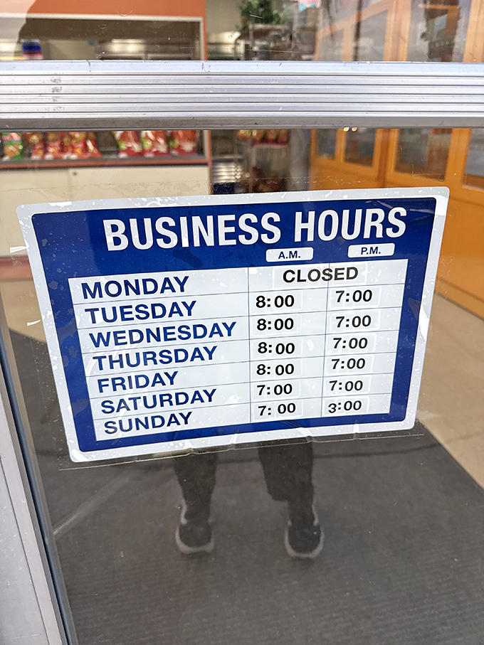 The business hours sign: a roadmap to tamale happiness. Note they're closed Mondays—even tamale artisans need a day off.