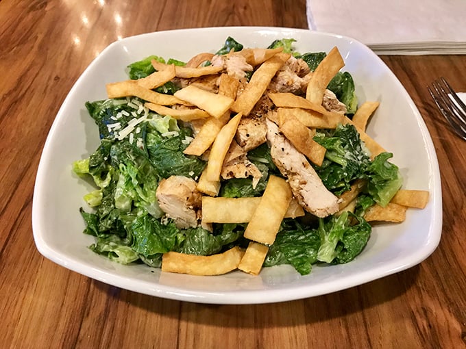 A Caesar salad that doesn't apologize for the addition of fries—because sometimes vegetables need carb companions to reach their full potential.
