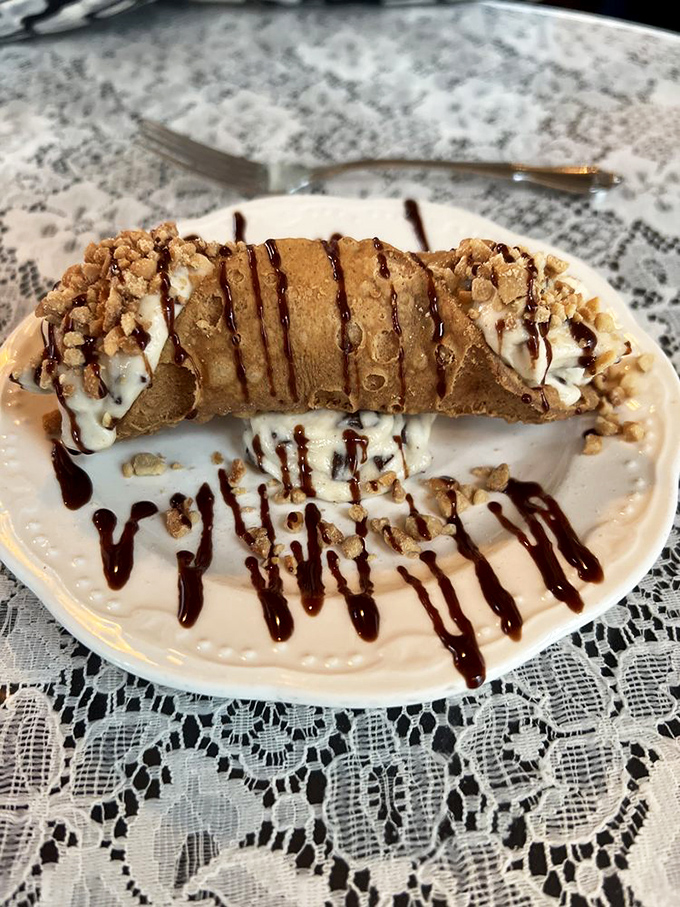 The cannoli—a sweet punctuation mark at the end of a perfect meal. Crisp shell, creamy filling, and chocolate drizzle create the dessert trifecta.