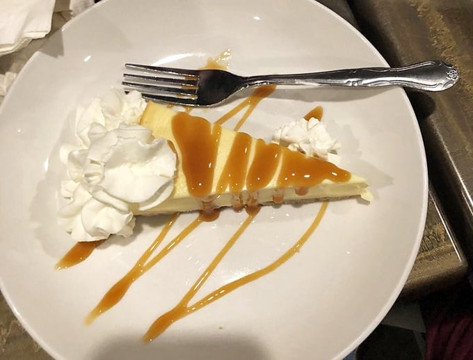 Cheesecake with caramel drizzle – proof that even after a seafood feast, there's always that separate dessert compartment waiting to be filled.