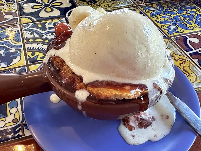 This isn't just dessert—it's the grand finale. Warm cherry cobbler meets cold ice cream in a romance for the ages.
