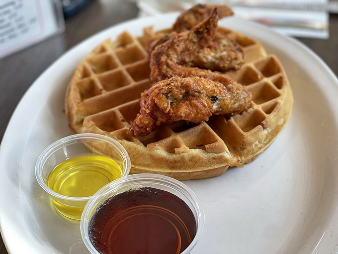 Chicken and waffles—the ultimate LA power couple. That golden waffle grid creating perfect pockets for syrup and butter is engineering at its most delicious.