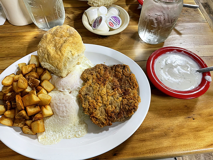 Country potatoes, a biscuit the size of your fist, and chicken fried steak—the holy trinity of heartland breakfast that puts cereal to shame.