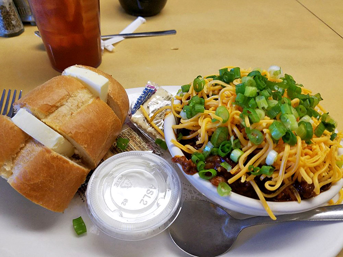 This isn't just chili—it's a bowl of comfort topped with enough cheese and green onions to make you forget whatever troubles followed you through the door.