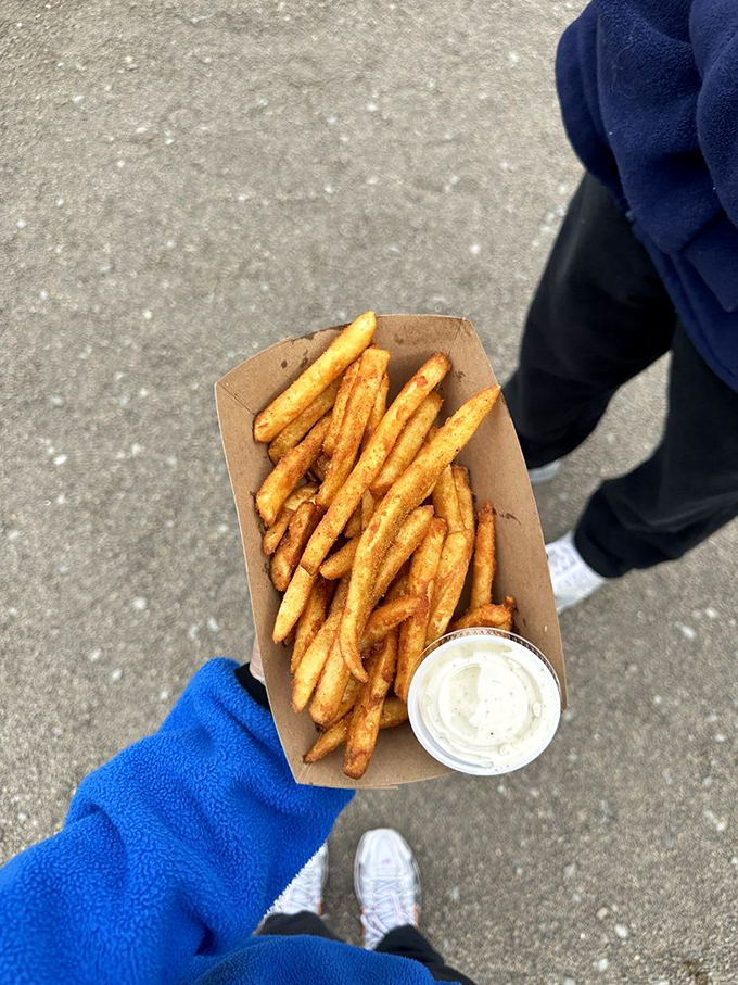 Sometimes happiness is as simple as perfectly golden fries and house-made tartar sauce, carried away like treasure from a coastal adventure.