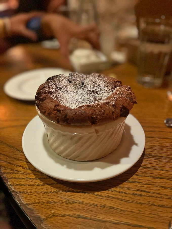 The chocolate soufflé rises to majestic heights before collapsing under your spoon's gentle pressure, revealing a center that defines the word "decadent."
