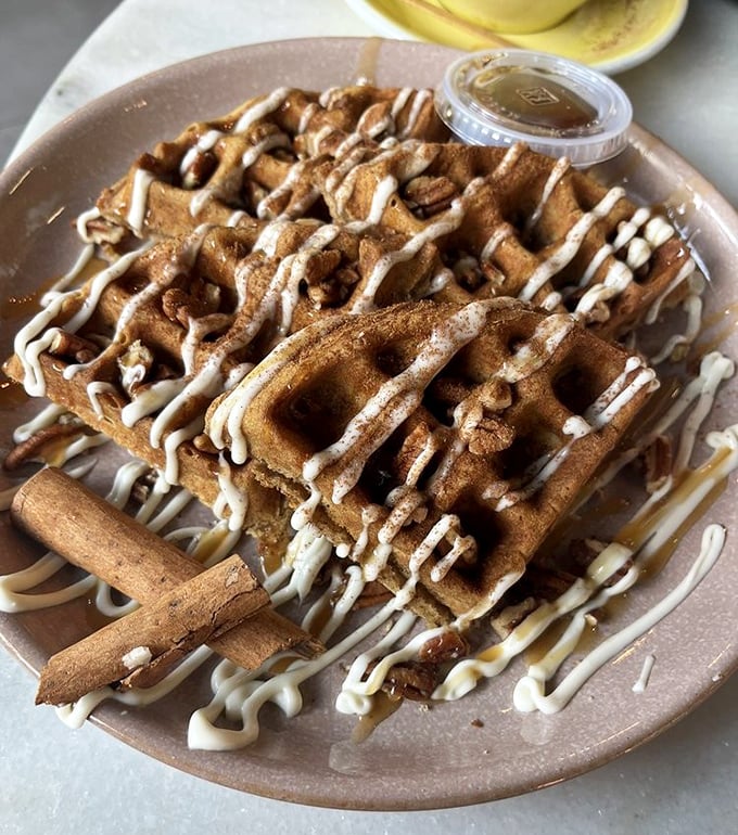 Waffles drizzled with such abandon they make Jackson Pollock look restrained. That cinnamon stick isn't just garnish – it's an exclamation point.
