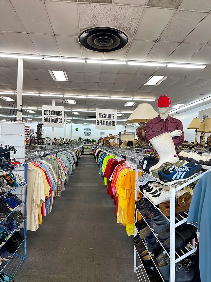 The men's department—where color-coded organization meets the thrill of potentially finding that perfect vintage bowling shirt or barely-worn designer steal.