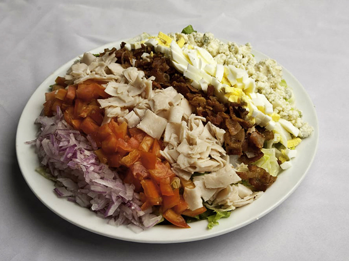 This Cobb salad is arranged with such precision it could teach a master class in color theory and flavor geography.