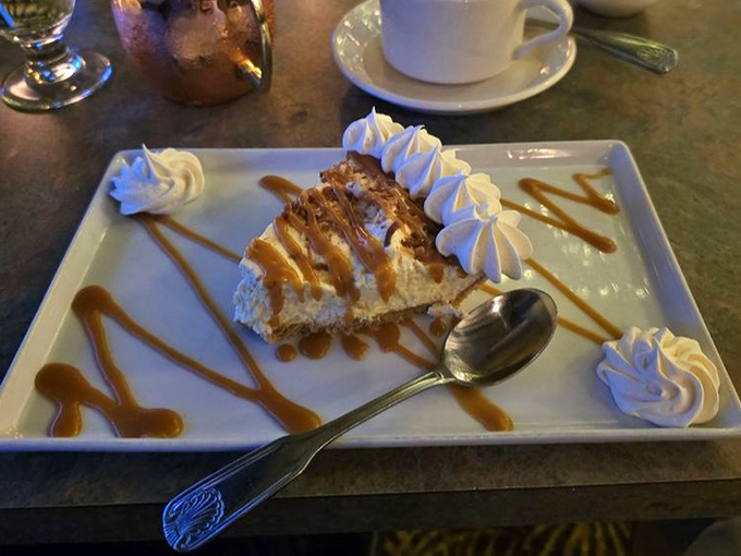 This coconut cream pie slice, artfully drizzled with caramel, isn't just dessert—it's the finale your taste buds have been waiting for.