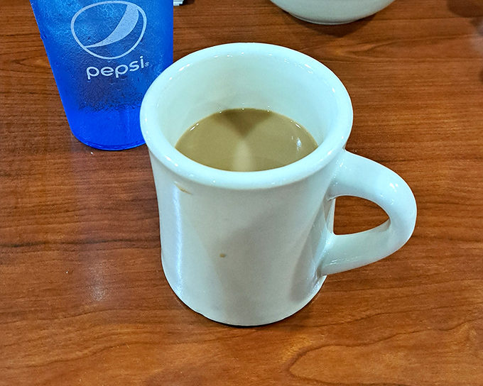 That classic white diner mug—holding what might be the most honest cup of coffee in Pennsylvania, no pretension, just pure caffeinated comfort.