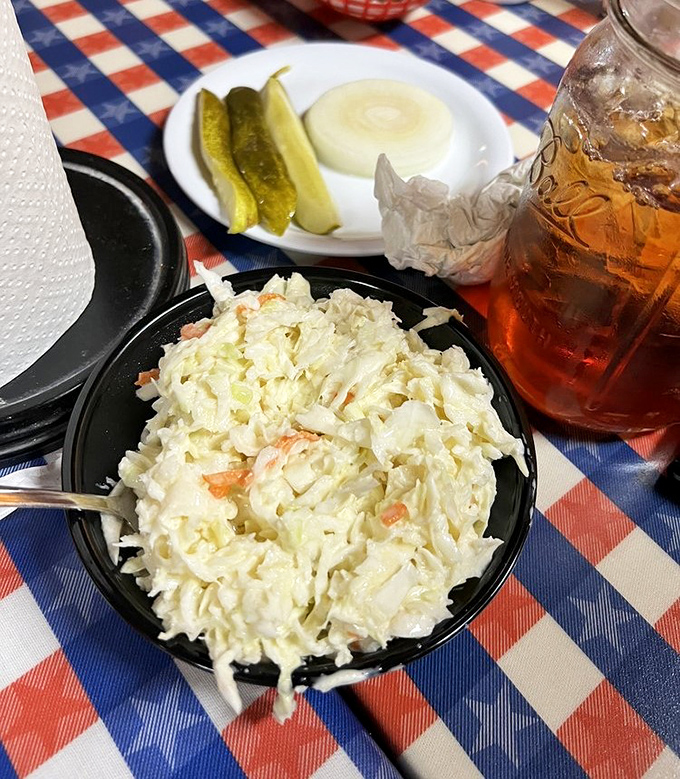 Creamy coleslaw that provides the perfect cool counterpoint to all that fried goodness. Notice the pickle spears standing by—nature's palate cleansers for the Southern feast.