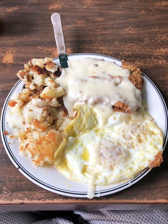 Country fried steak smothered in gravy with eggs sunny-side up—proof that sometimes the most photogenic food isn't on fancy plates, but in classic diners.