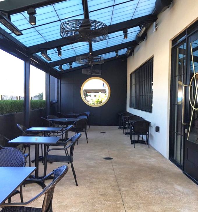 The covered patio offers a serene escape—where the Florida sunshine filters through blue panels, creating the perfect lighting for both contemplation and consumption.