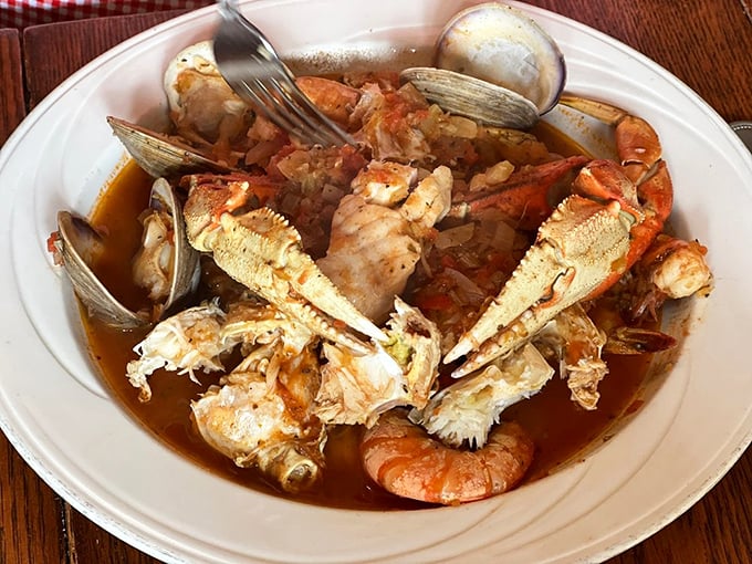 Cioppino that looks like it was made by someone's Italian grandmother—a glorious mess of shellfish and crab claws in a tomato broth worth sopping up with bread.