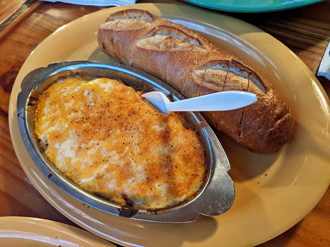Crab dip that threatens to upstage the main course—creamy, cheesy, and demanding to be scooped up with that crusty bread.