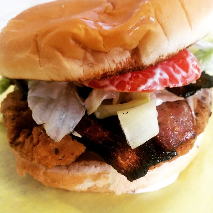 This isn't just a chicken sandwich—it's a skyscraper of flavor with bacon buttresses and vegetable viewpoints. Architectural deliciousness.