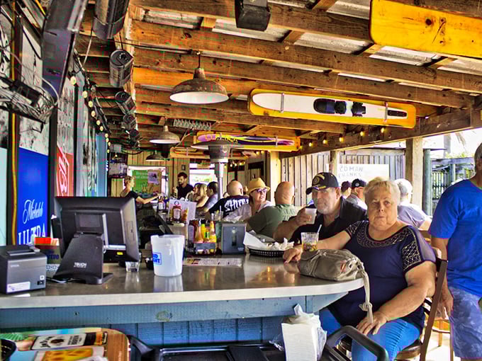 The bar at Old Man Frank's isn't just serving drinks—it's serving community, conversation, and the kind of Florida afternoon that tourist brochures can only dream about.