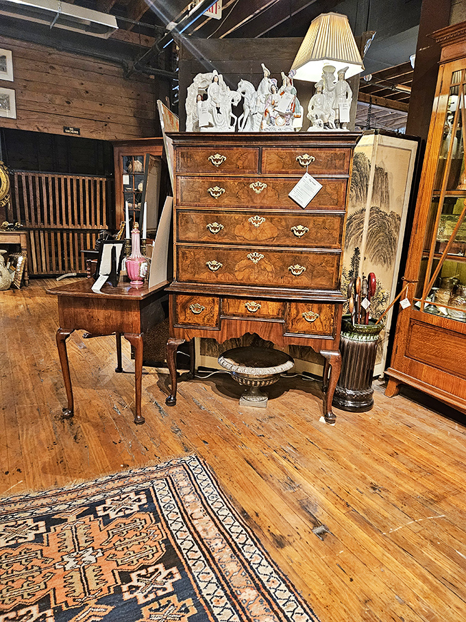 The highboy of your dreams stands tall, wearing its burled wood like couture. Those brass handles have opened drawers for generations of well-dressed owners.