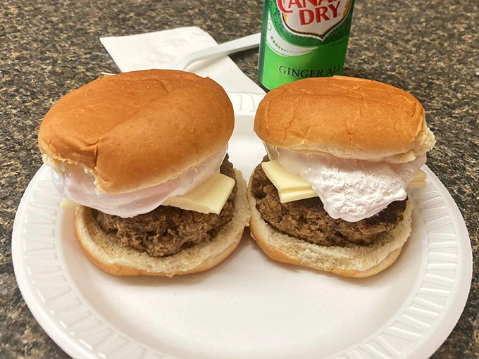 These burgers with their pillowy white topping aren't just food – they're an engineering marvel of texture and flavor that demands respect.