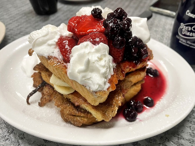 This French toast stack with fresh berries isn't just breakfast – it's what dessert dreams about when it goes to sleep at night.