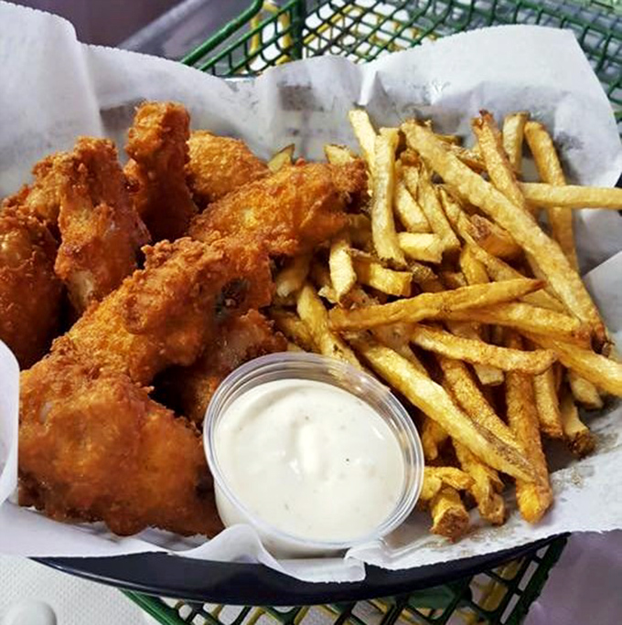 The fried basket arrives like a treasure chest of comfort—golden chicken, hand-cut fries, and house-made dipping sauce that makes fast food chains weep with inadequacy.