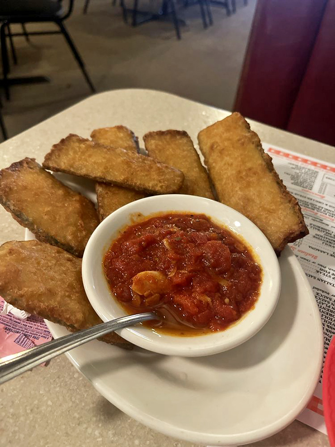 Golden-fried zucchini planks with marinara for dipping – the perfect starter while you wait for the main event to arrive.