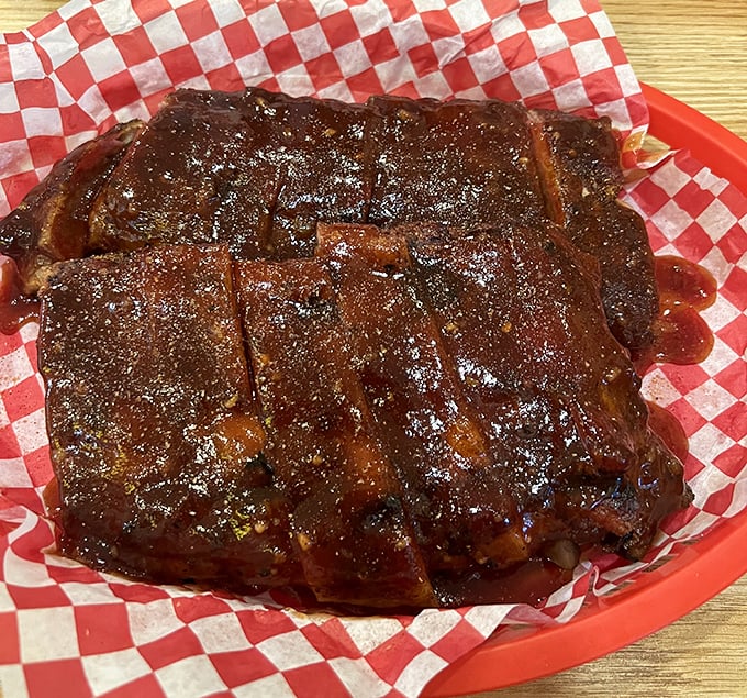 Ribs lacquered with sauce so glossy you could check your reflection before diving in. Napkins required, no judgment passed.