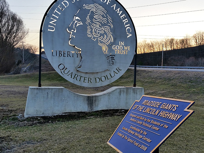 The informational plaque reveals the quarter's origin story—a testament to local students' creativity and the preservation of roadside culture.