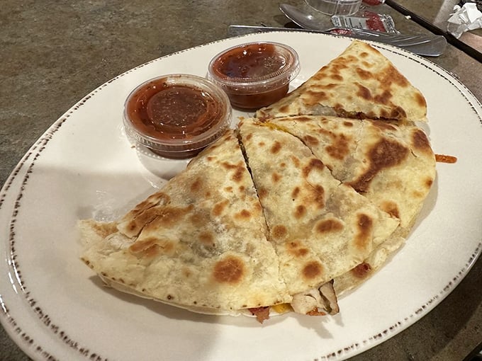 The quesadilla arrives golden-brown and crispy, flanked by salsa sentries—proof that Lyn-Way excels beyond its famous comfort food classics.