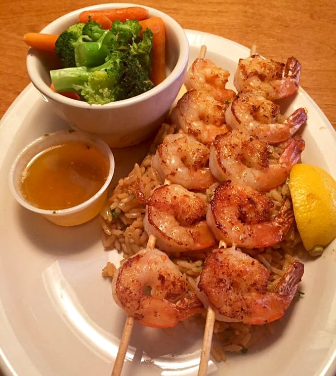 These grilled shrimp look like they're performing a synchronized swimming routine across a pool of seasoned rice.
