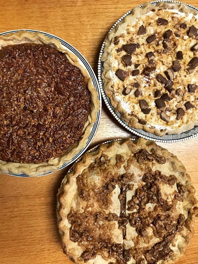 Pie paradise! Pecan, chocolate chip, and what appears to be a classic custard—Crabill's homemade pies provide the perfect finale to your burger adventure.