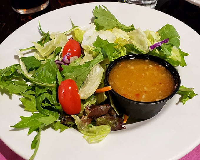 A house salad that doesn't just phone it in—fresh greens and vibrant tomatoes that remind you vegetables have a place at a steakhouse too.