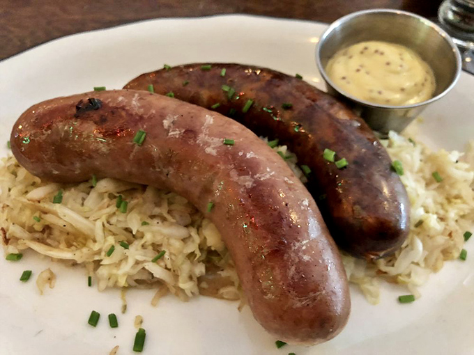 Housemade sausages resting on a bed of sauerkraut. These aren't just links—they're edible history lessons in Pennsylvania Dutch culinary tradition.