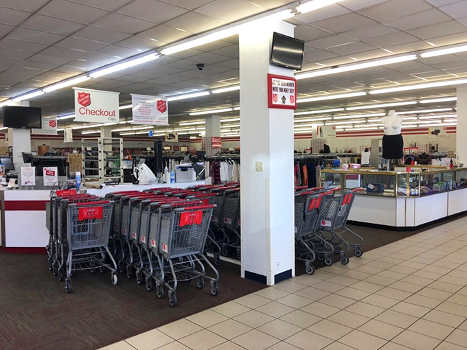 The checkout area stands ready with red carts and friendly cashiers—the final step in transforming someone's donations into another person's treasures.