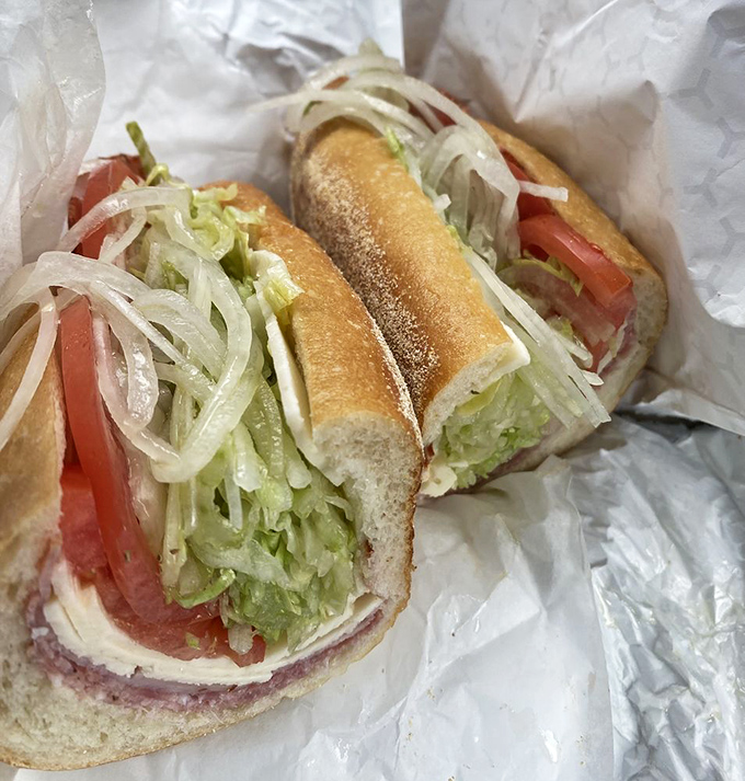 The Italian hoagie in its natural habitat – simple white paper that will soon bear the honored stains of oil, vinegar, and satisfaction.