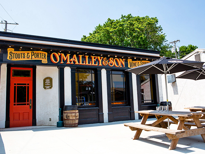 O'Malley's invites passersby with its vintage sign and picnic tables—a hint of the underground pub experience waiting below.