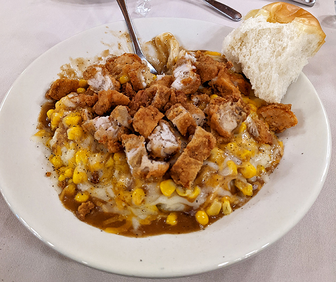 A bowl of pure Midwestern soul – creamy mashed potatoes topped with crispy chicken and sweet corn. Spoons were invented for moments like this.