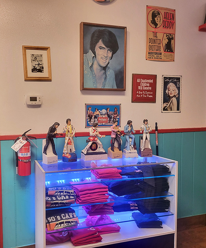 Elvis watches over his kingdom of memorabilia and branded merchandise. Those figurines aren't just collectibles – they're tiny ambassadors from the golden age of rock.