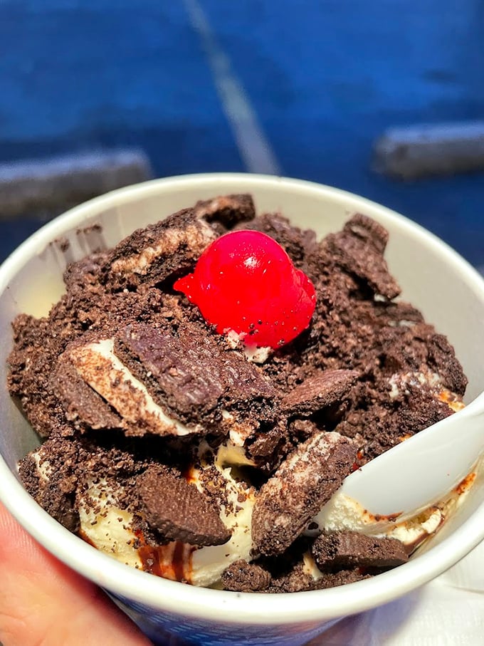 Chocolate crumbles, vanilla ice cream, and that signature cherry—a kid's sundae that makes adults seriously consider ordering from the children's menu.